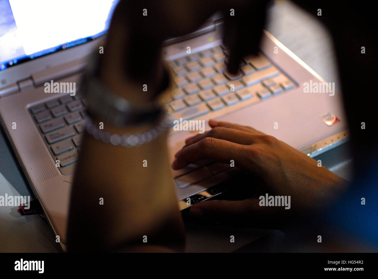 Young woman using a laptop computer at night Stock Photo - Alamy