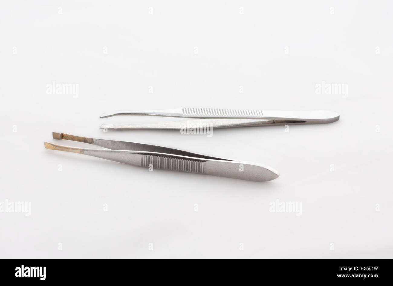 Two steel tweezers on a white background, isolated Stock Photo - Alamy