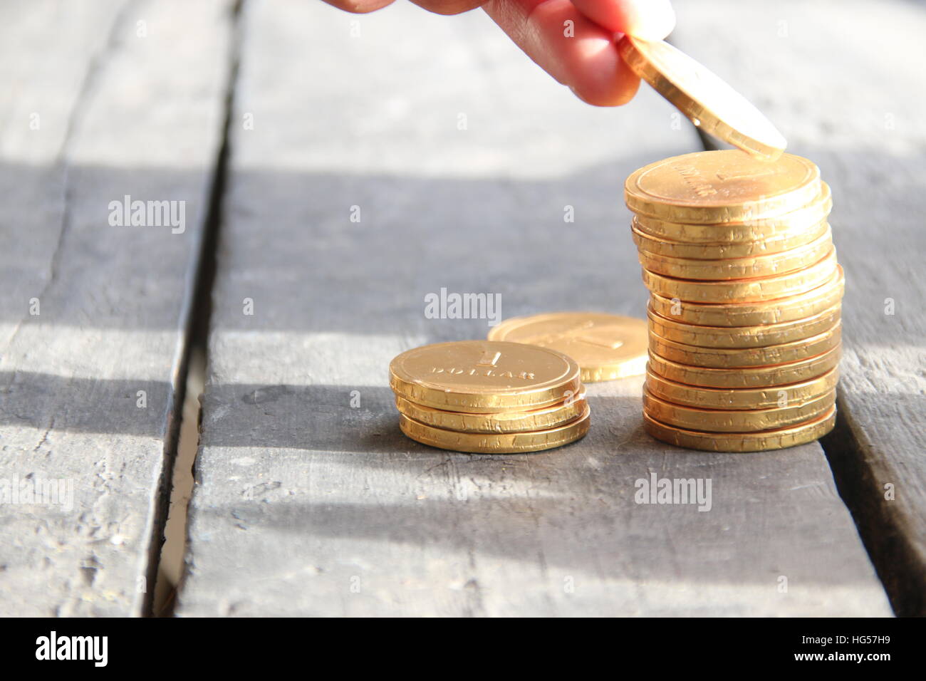 Hand stacking gold coins hi-res stock photography and images - Alamy
