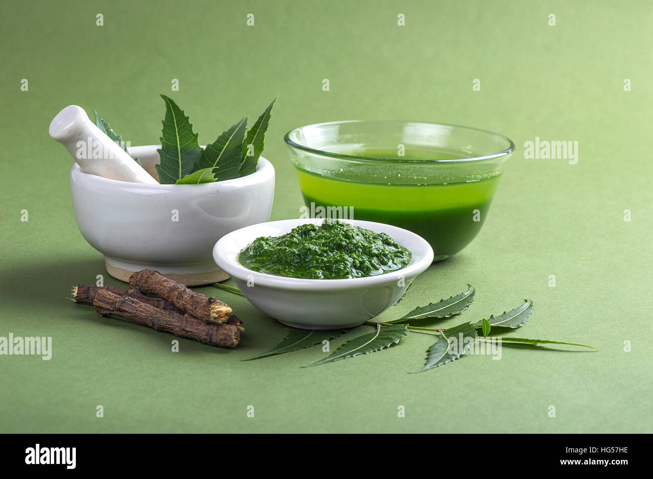 Medicinal Neem leaves in mortar and pestle with neem paste, juice and ...