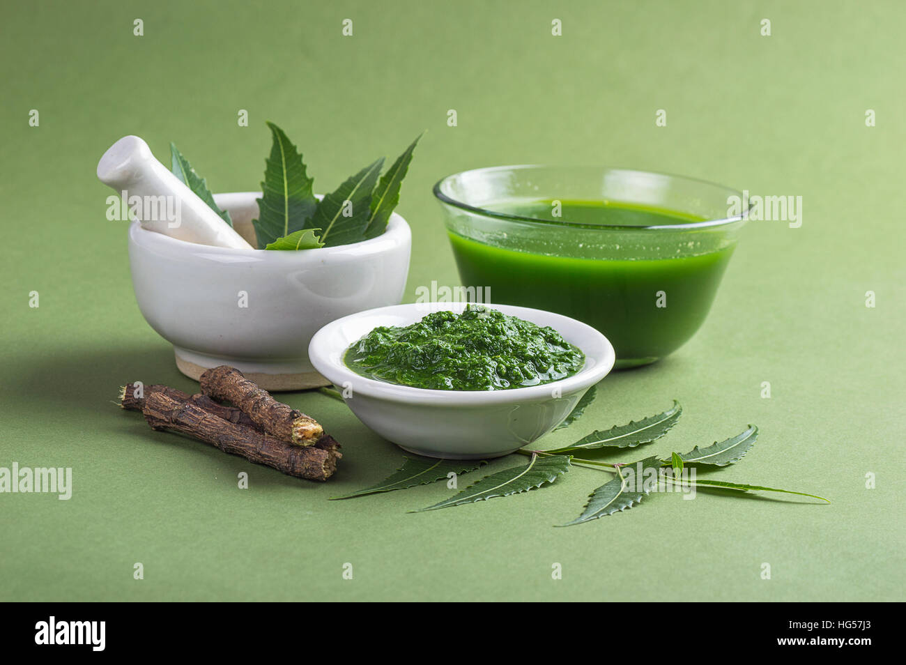 Medicinal Neem leaves in mortar and pestle with neem paste, juice and ...