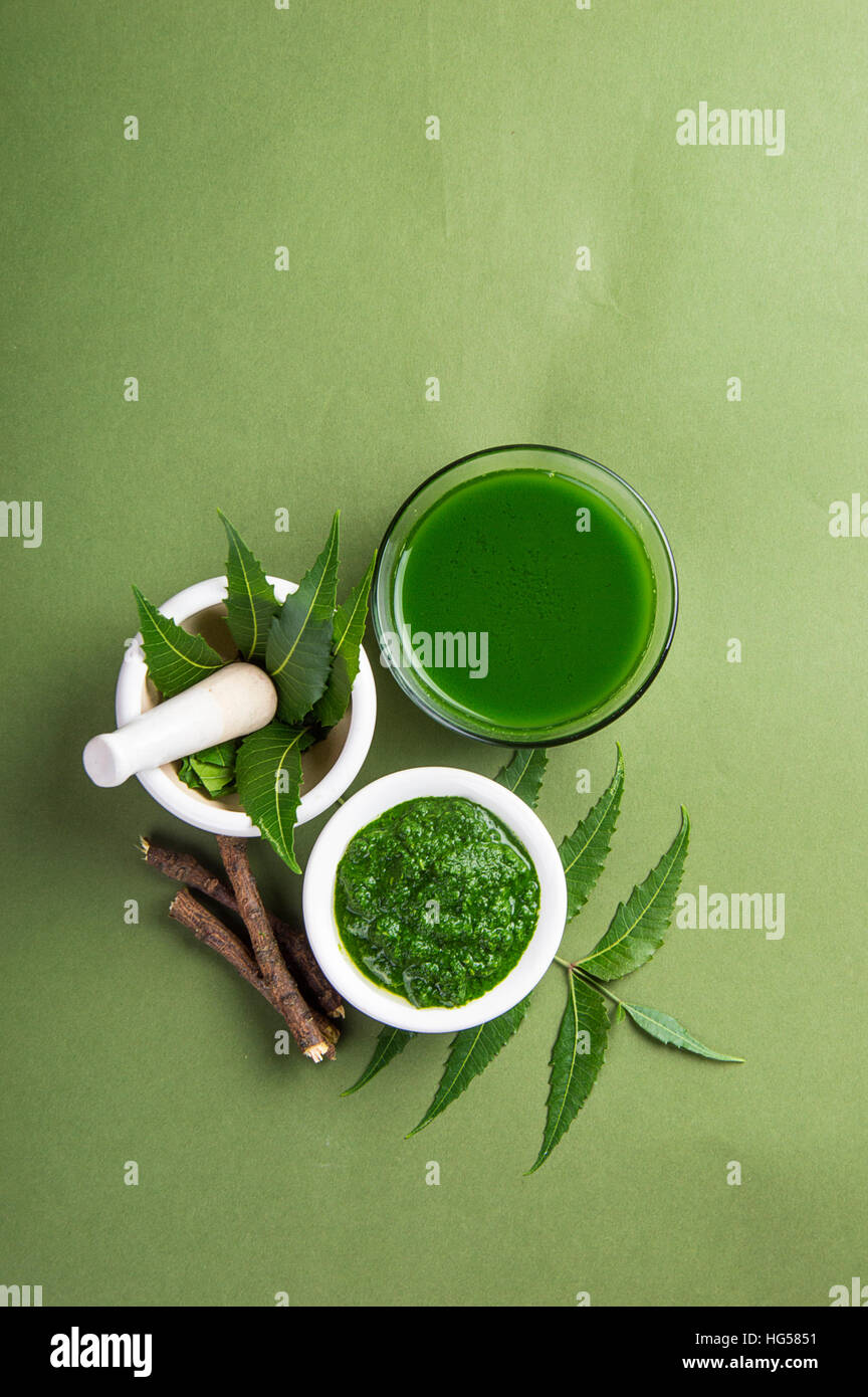 Medicinal Neem leaves in mortar and pestle with neem paste, juice and ...