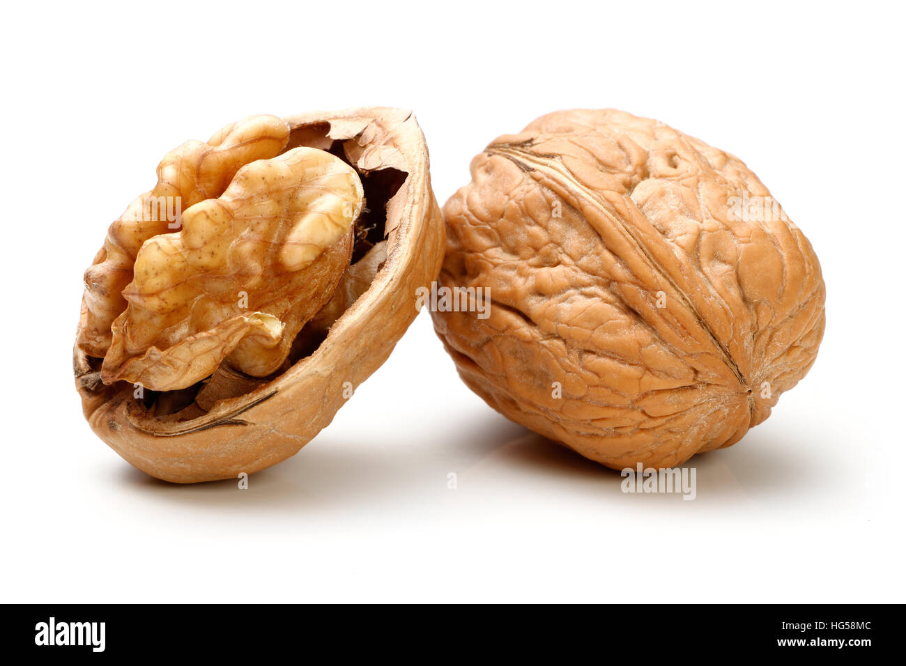 Whole walnut and half walnut piece Stock Photo - Alamy