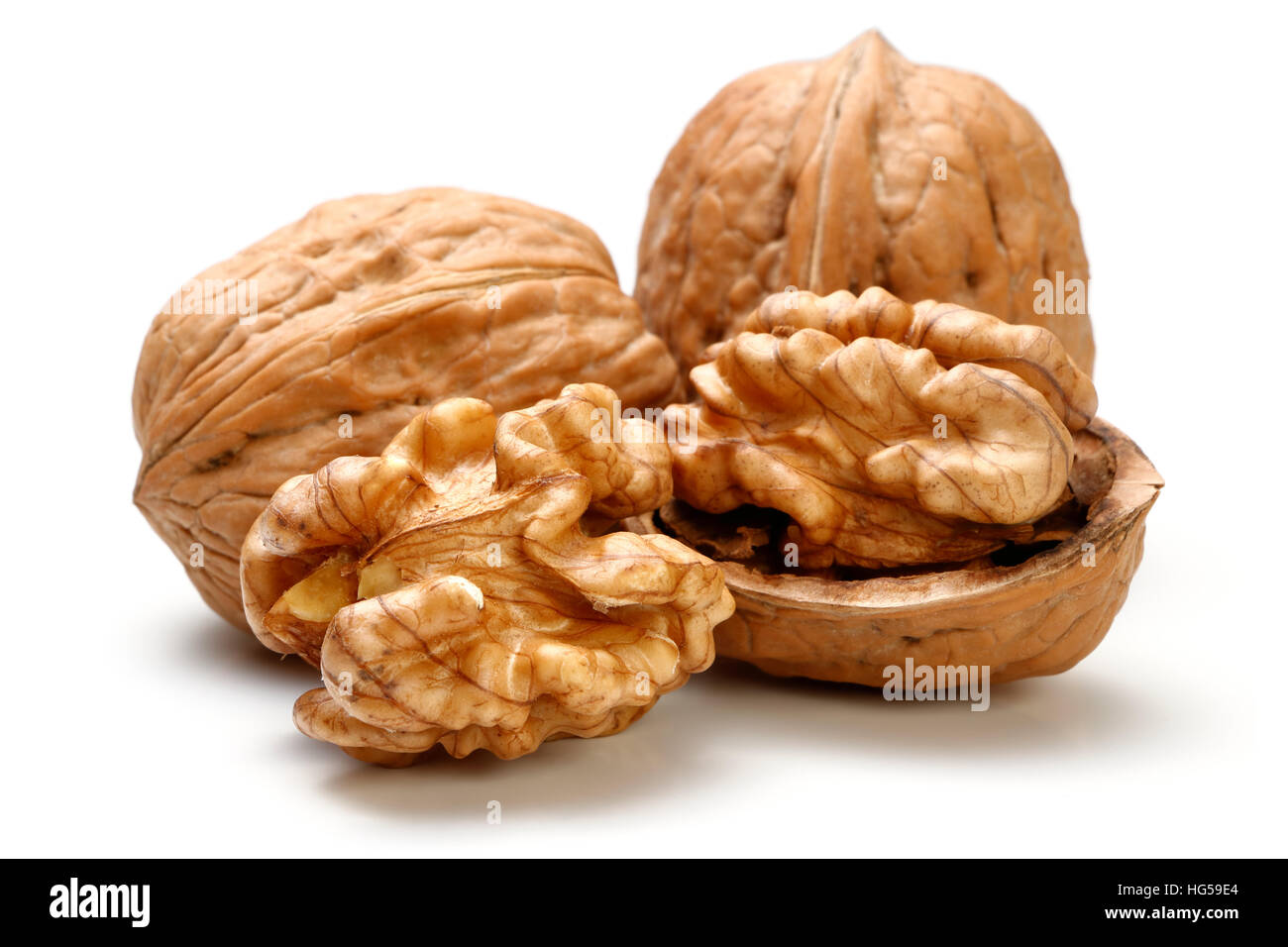 Whole walnut and half walnut piece Stock Photo - Alamy