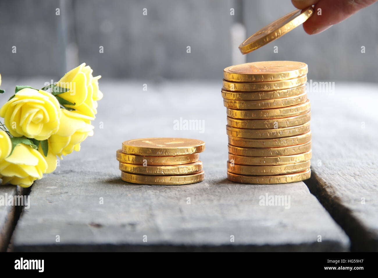 hand holding gold coins and nice flowers Stock Photo - Alamy