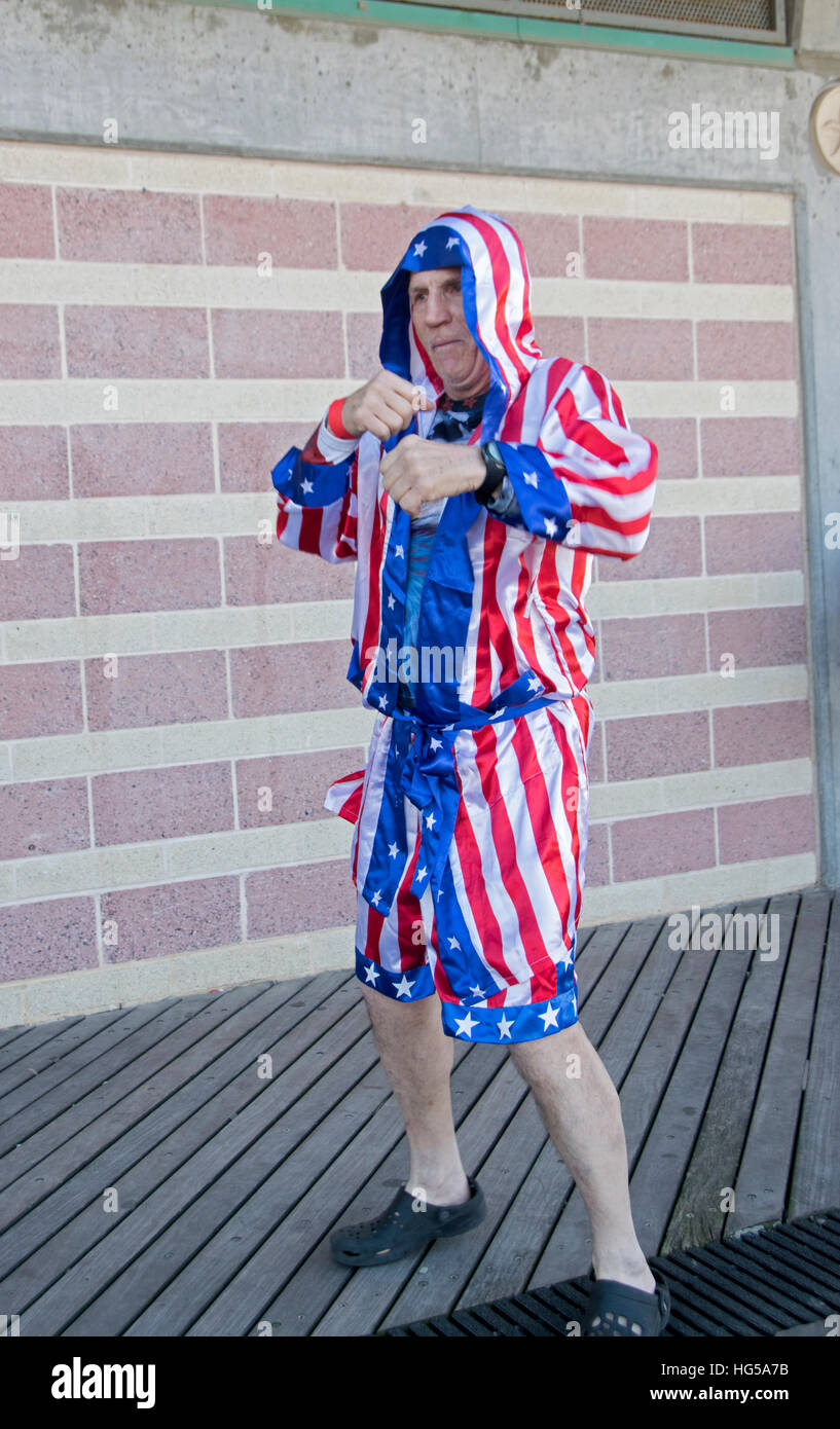 A retired 70 year old boxer in a stars & Stripes robe poses in Coney ...