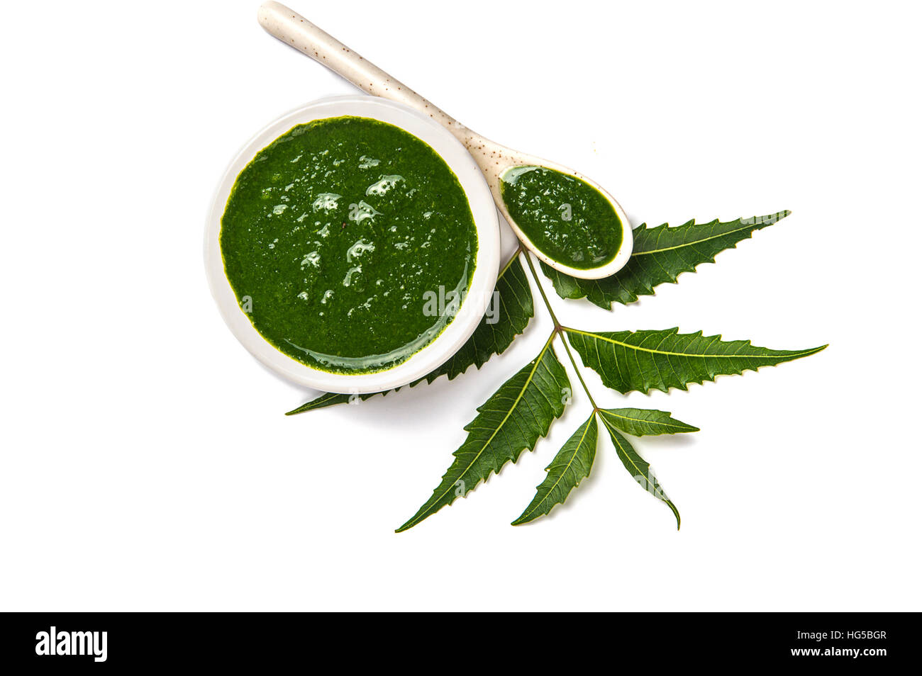 Medicinal Neem leaves with neem paste in spoon and plate on white ...