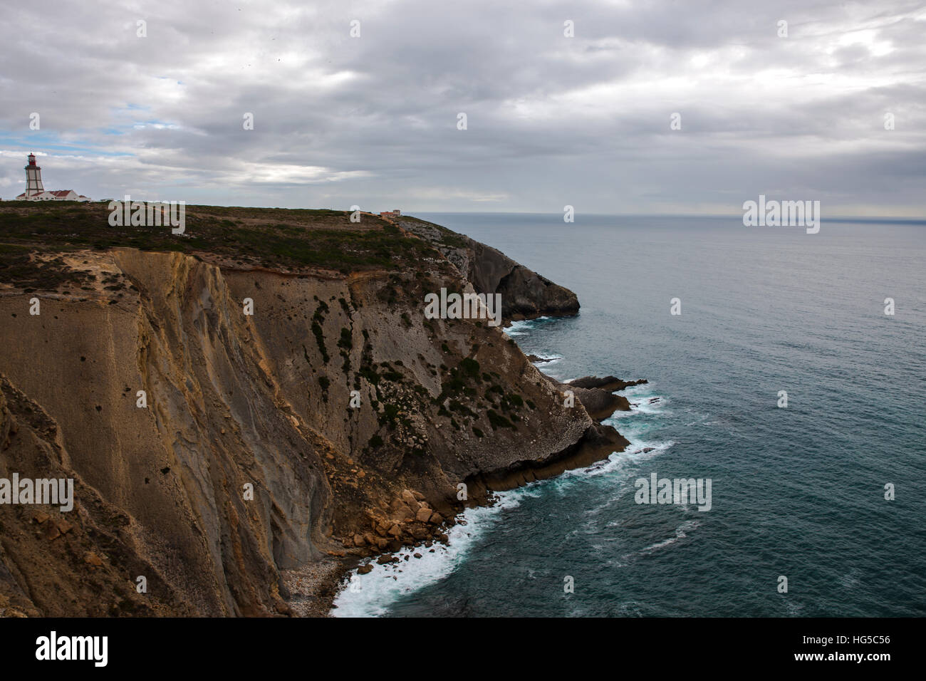 The Cabo Espichel coast on the Atlantic Ocean with lighthouse in the distance, Lisbon, Portugal ...