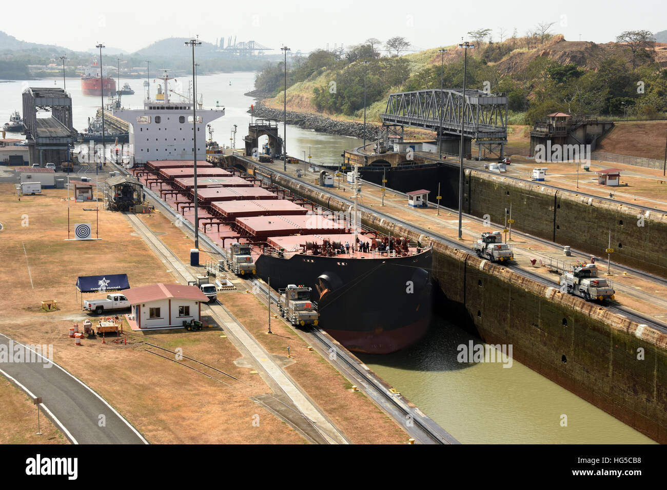 Electric mules guiding Panamax ship through Miraflores Locks on the ...