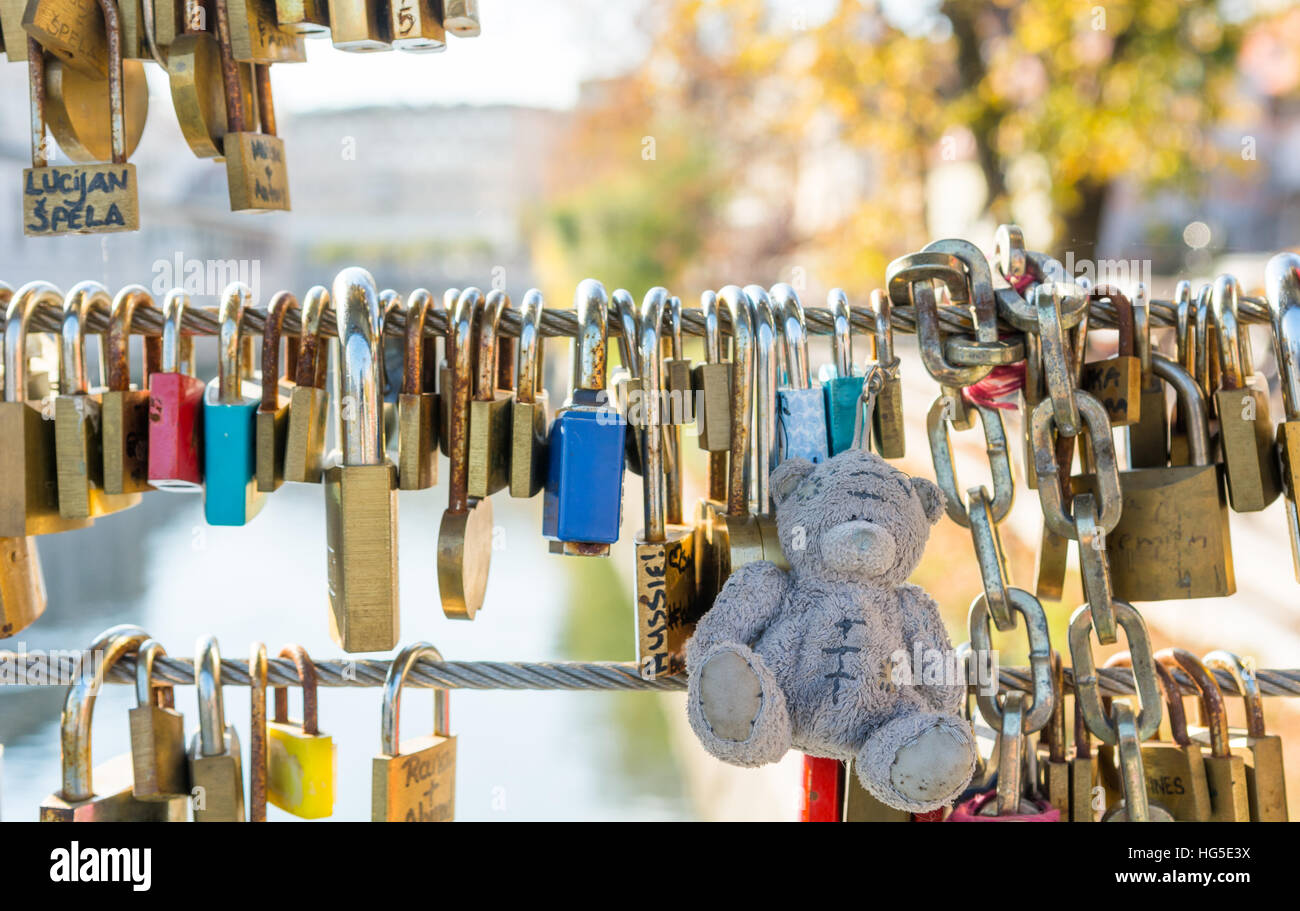 Teddy bear with love locks on a metal bridge Stock Photo - Alamy