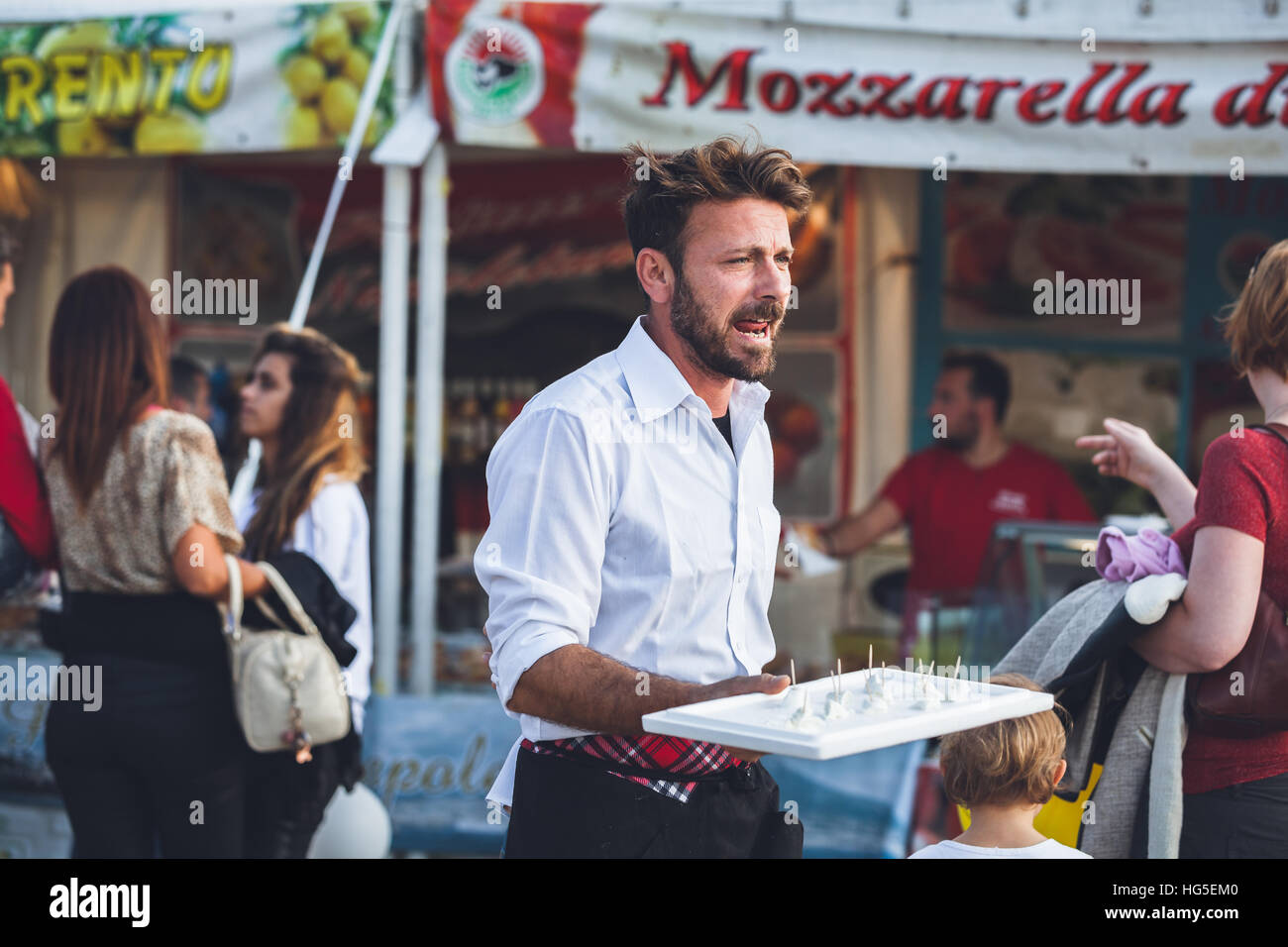 Young italian man offering for taste free mozzarella samples Stock ...