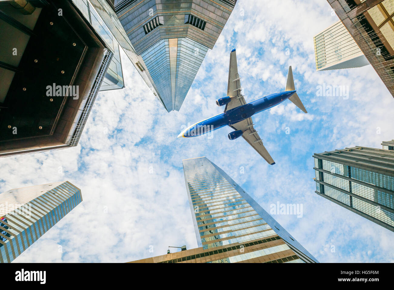 Airplane above city Stock Photo - Alamy