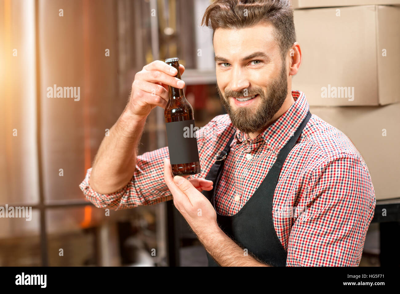 Brewer with bottle at the manufacturing Stock Photo - Alamy