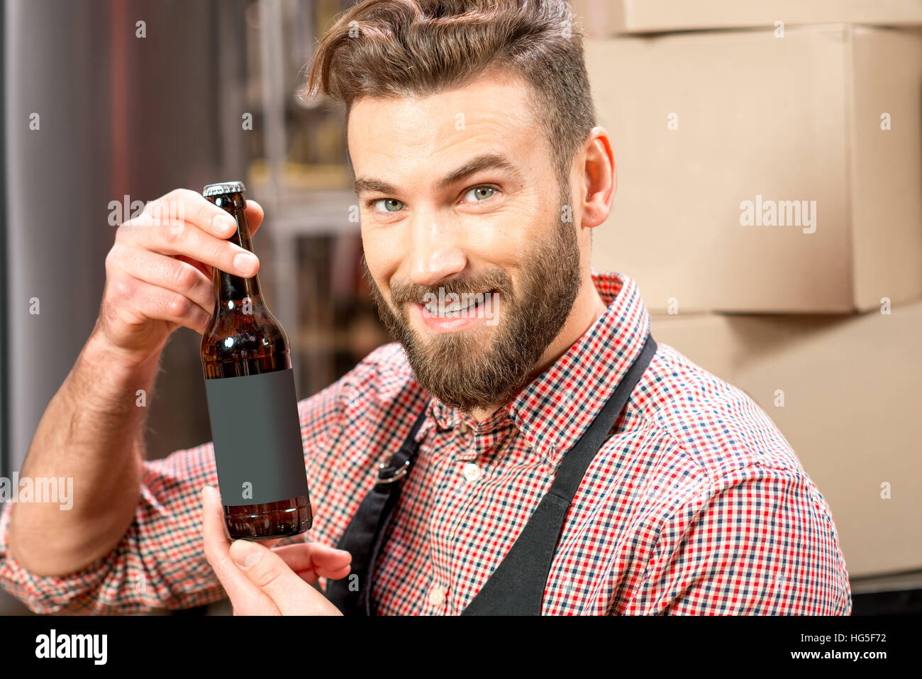 Brewer with bottle at the manufacturing Stock Photo - Alamy