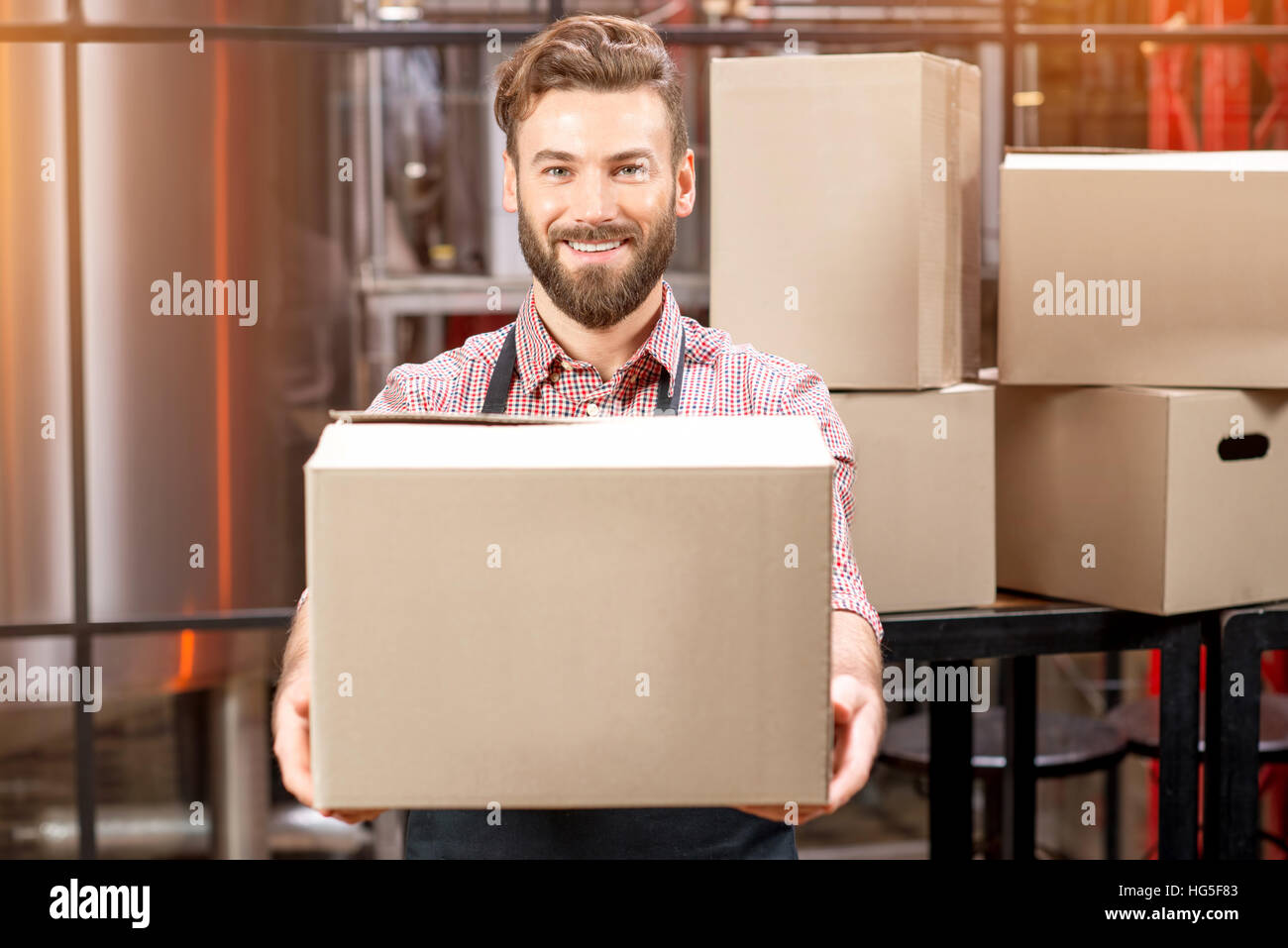 Professional courier with boxes Stock Photo - Alamy