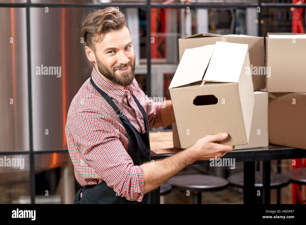 Professional courier with boxes Stock Photo - Alamy