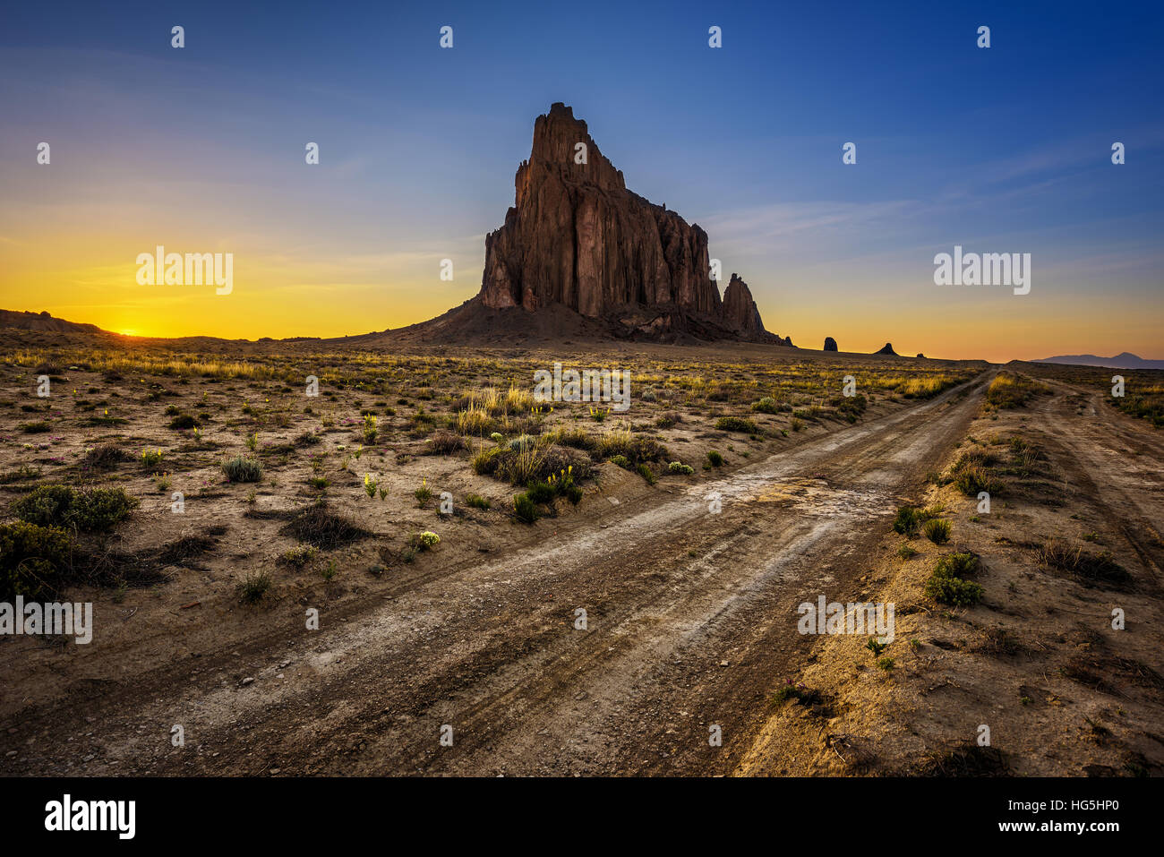 Sunset above Shiprock. Shiprock is a great volcanic rock mountain ...