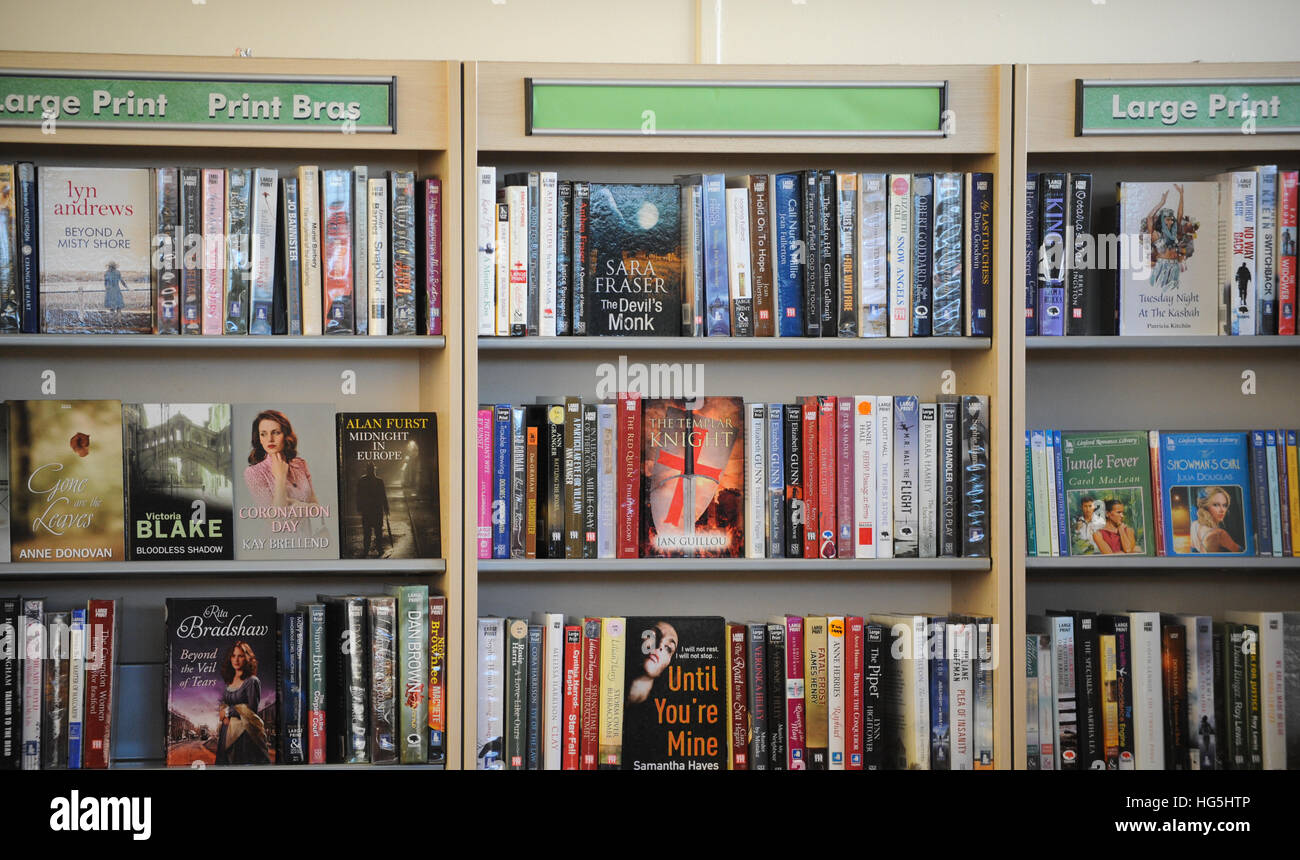 Books lines up on a library shelf Stock Photo - Alamy