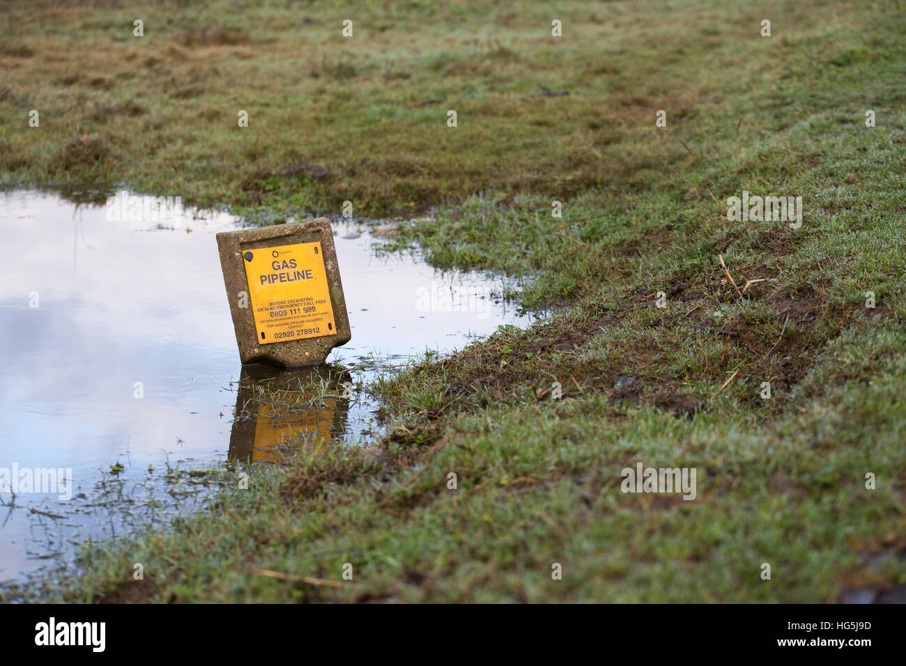Gas pipeline sign in a puddle of water Stock Photo - Alamy