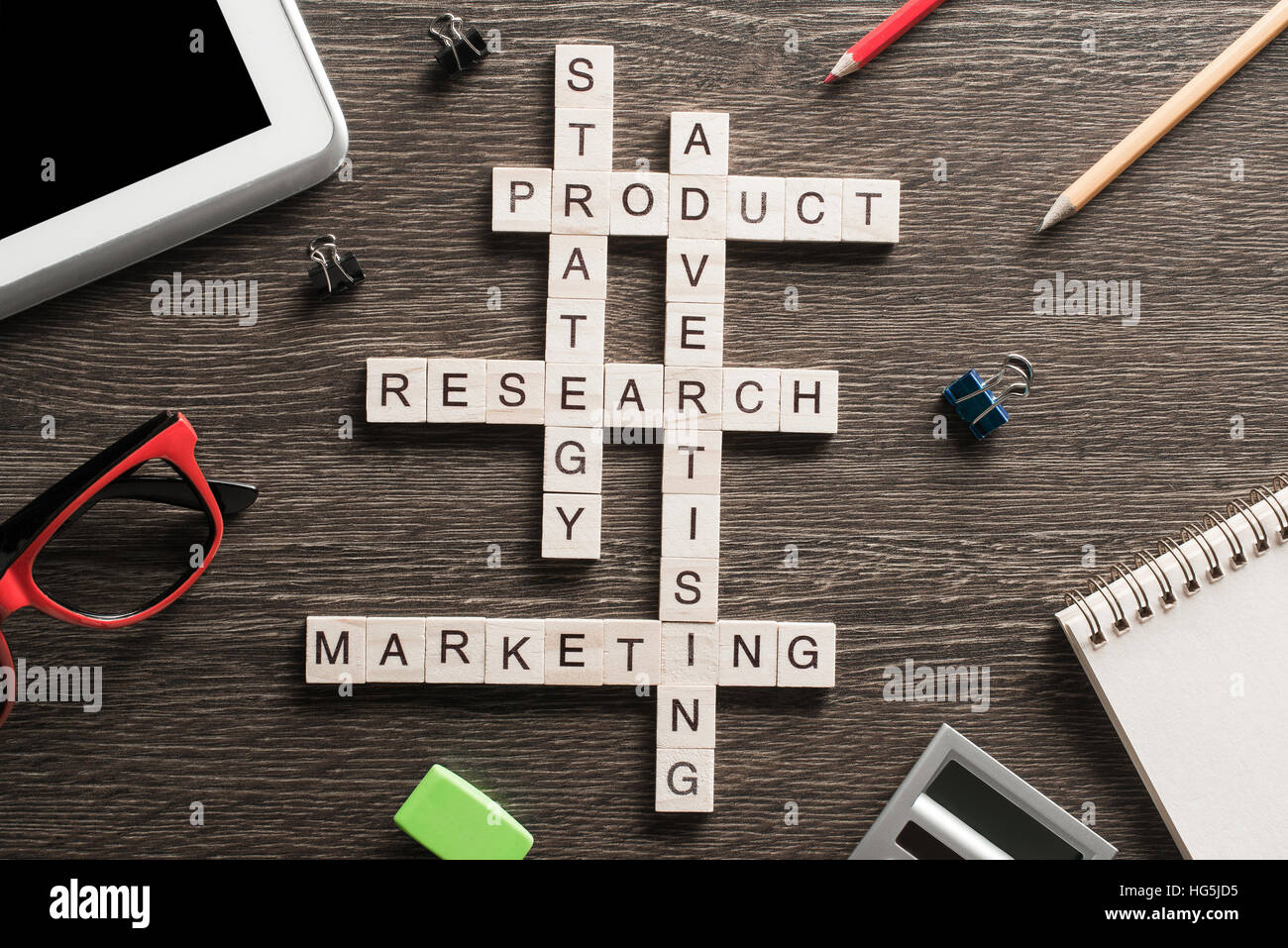 Business workplace with office stuff and wooden cubes making crossword ...