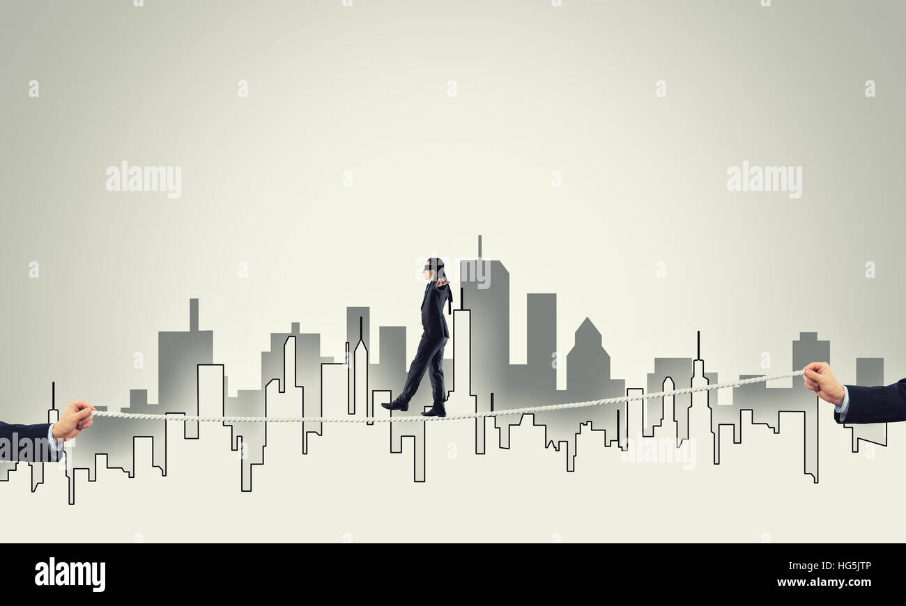 Business concept of risk support and assistance with man balancing on ...