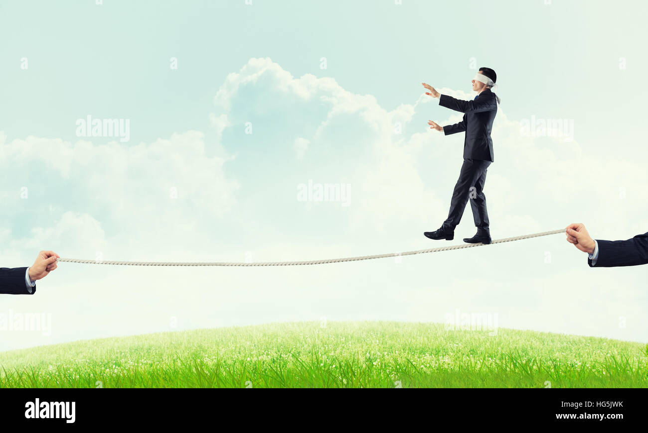 Business concept of risk support and assistance with man balancing on ...