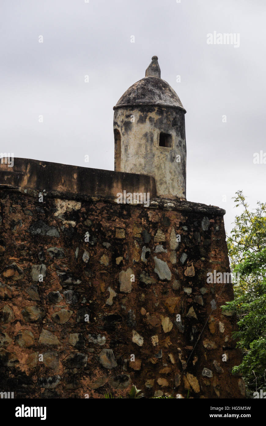 Part of an old fort, with a side of a watchtower over a wall made of ...