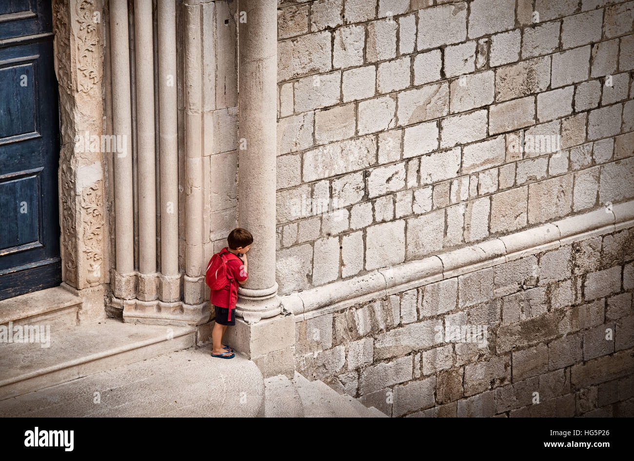 Man Hiding Behind Wall