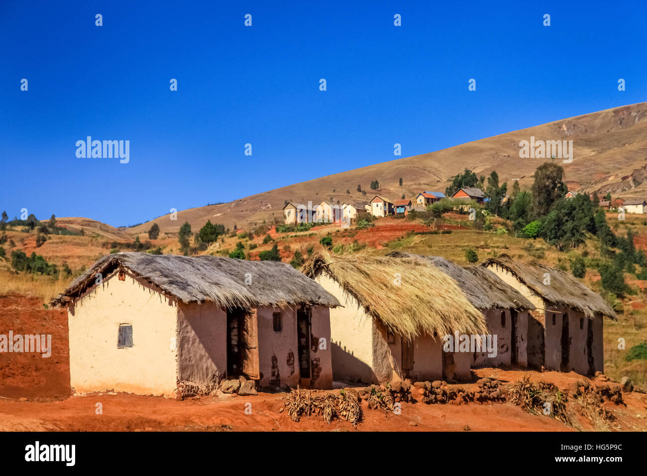 Row of four primitive huts in central plateau in Madagascar Stock Photo ...