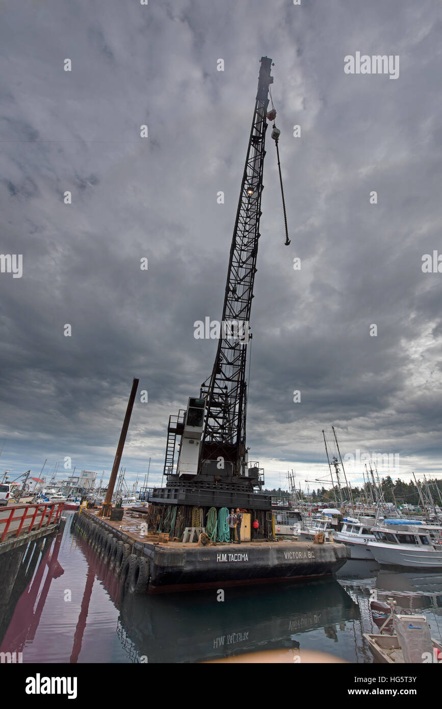 Pile driving crane on floating barge working in French creek harbour ...