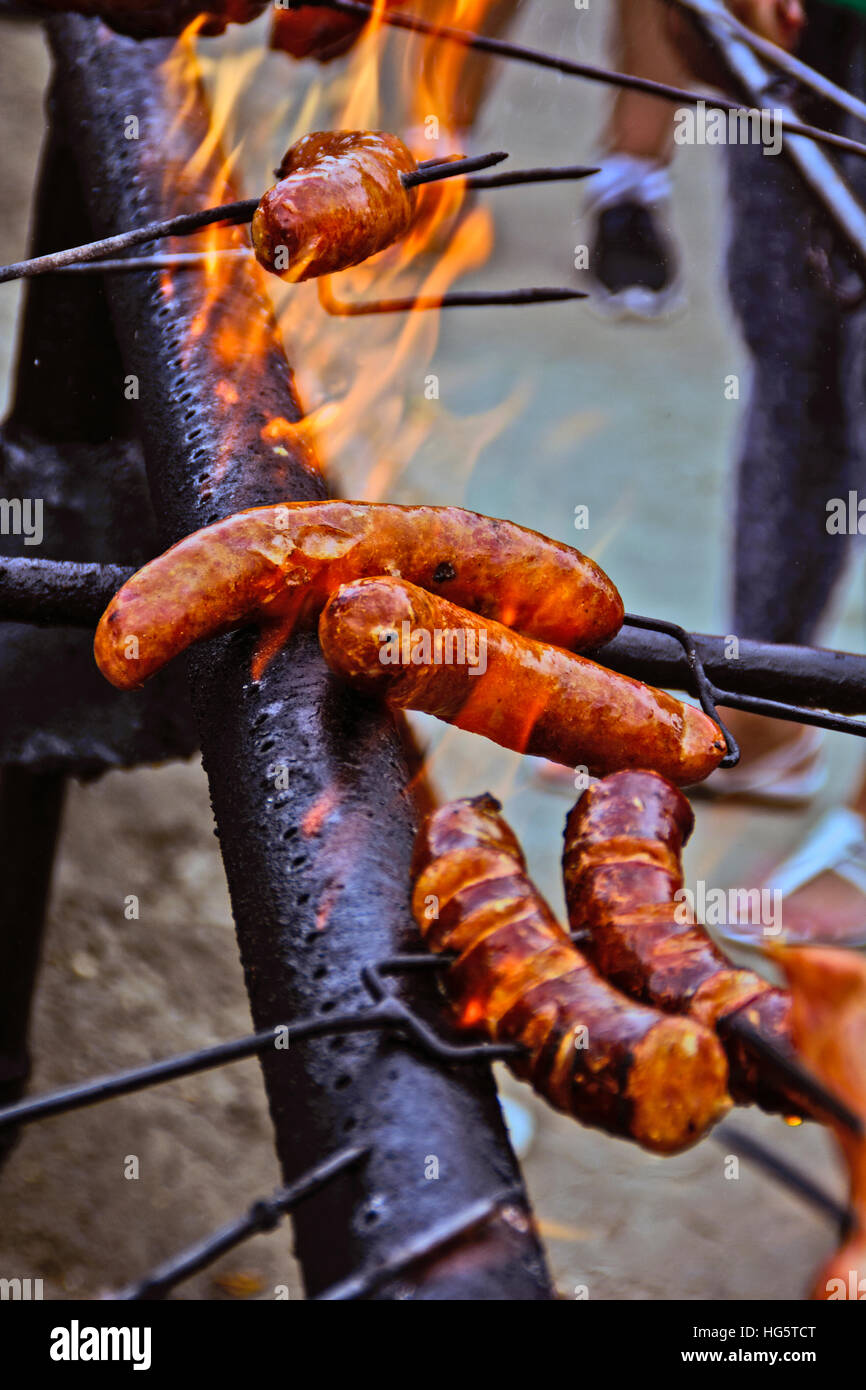 The traditional roast sausage on fire during the manifestations Stock ...