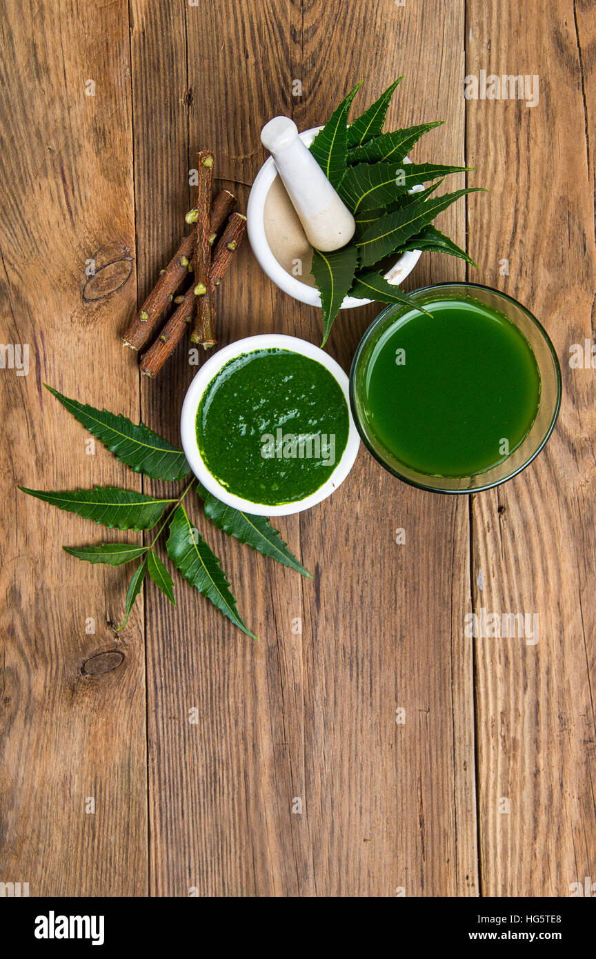 Medicinal Neem leaves in mortar and pestle with neem paste, juice and ...