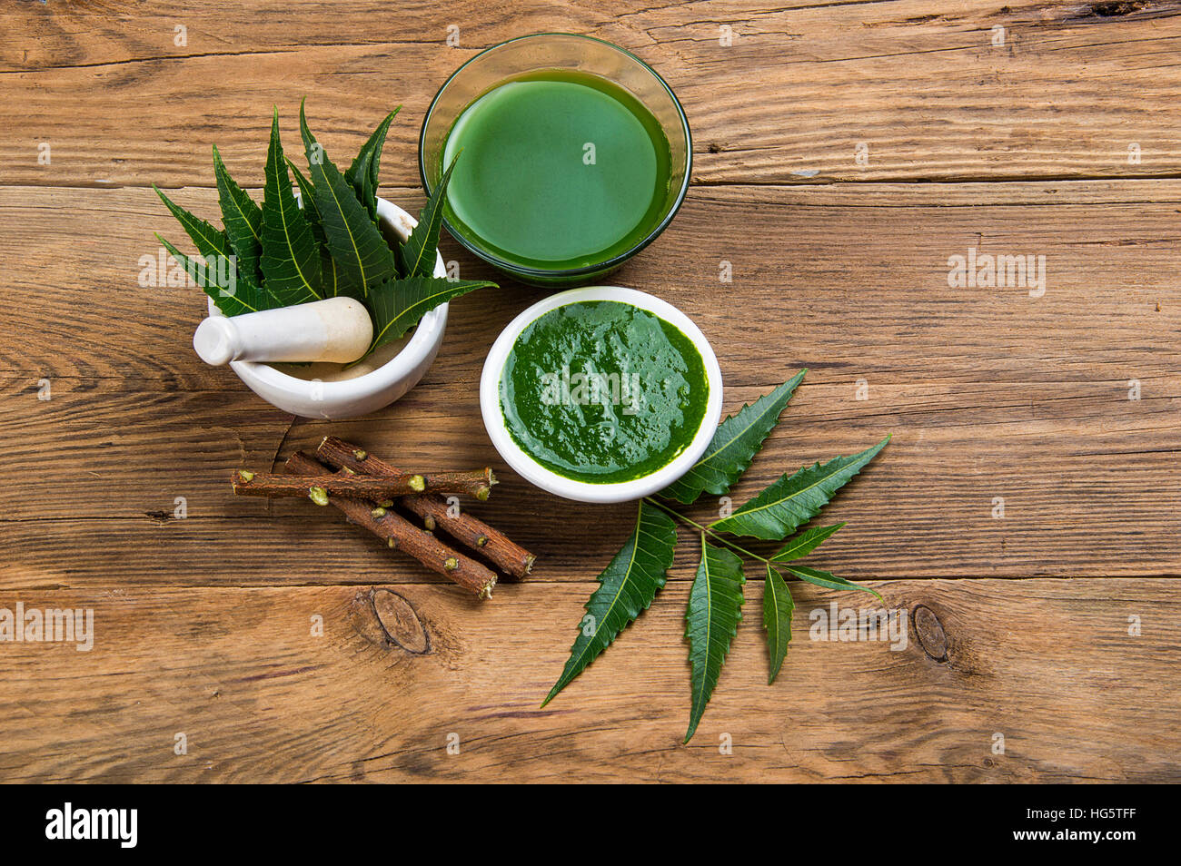 Medicinal Neem leaves in mortar and pestle with neem paste, juice and ...