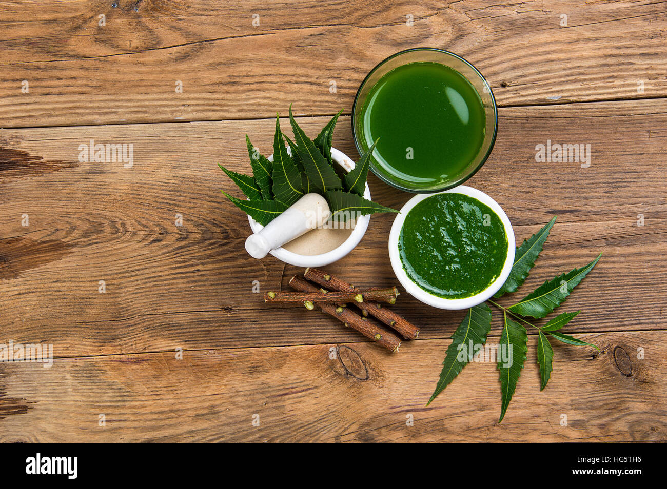 Medicinal Neem leaves in mortar and pestle with neem paste, juice and ...