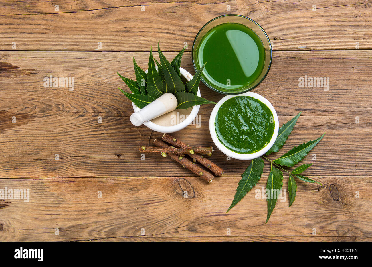 Medicinal Neem leaves in mortar and pestle with neem paste, juice and ...