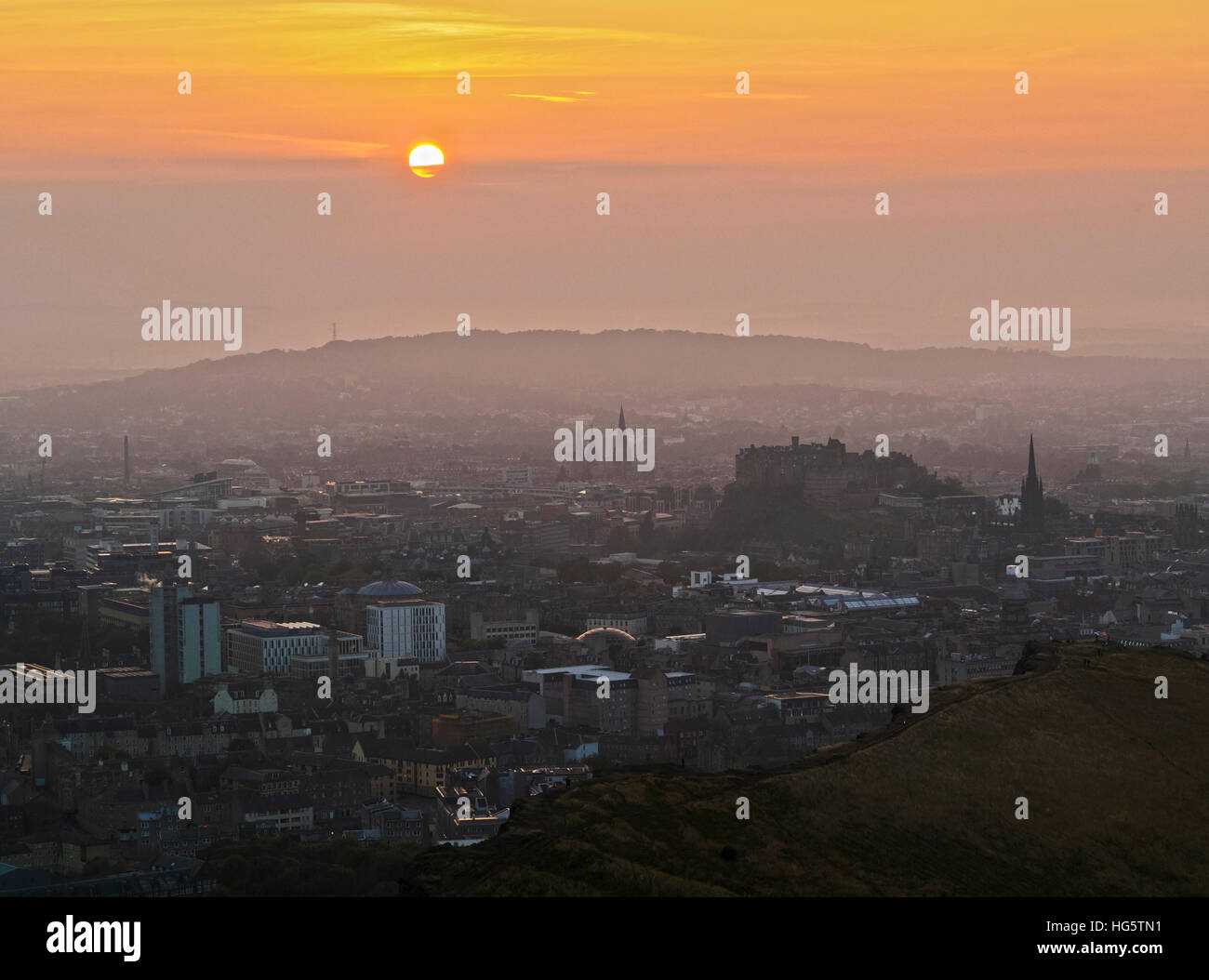 UK, Scotland, Lothian, Edinburgh, Holyrood Park, Sunset over the city ...