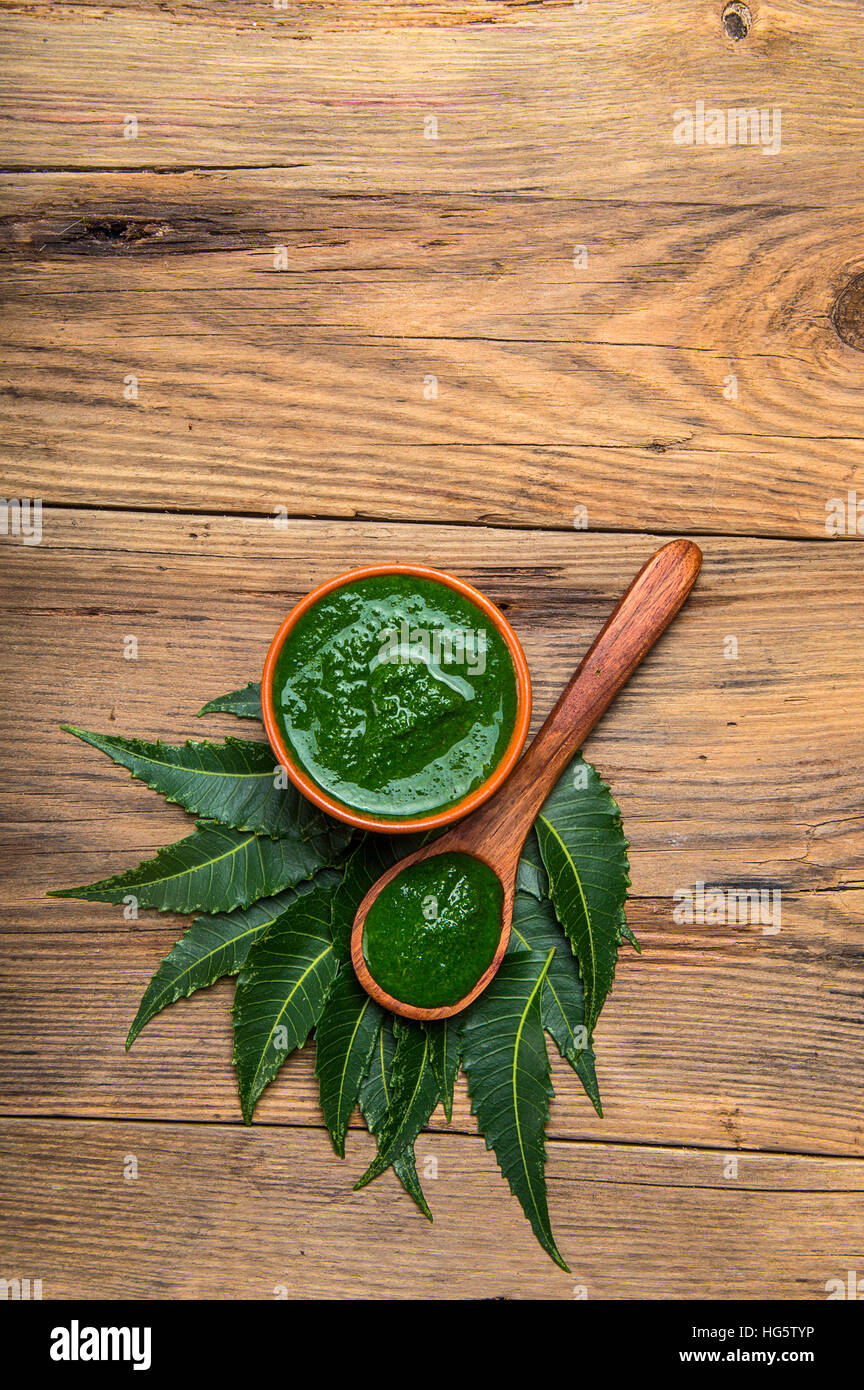Medicinal Neem leaves with paste on wooden background Stock Photo - Alamy