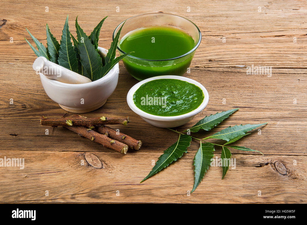 Medicinal Neem leaves in mortar and pestle with neem paste, juice and ...