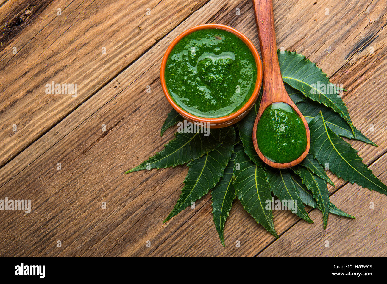 Medicinal Neem leaves with paste on wooden background Stock Photo - Alamy