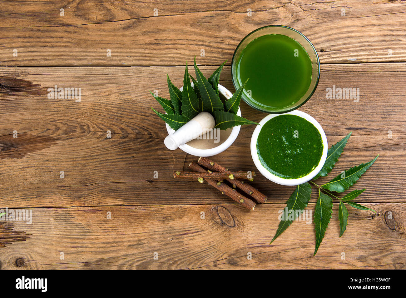Medicinal Neem leaves in mortar and pestle with neem paste, juice and ...