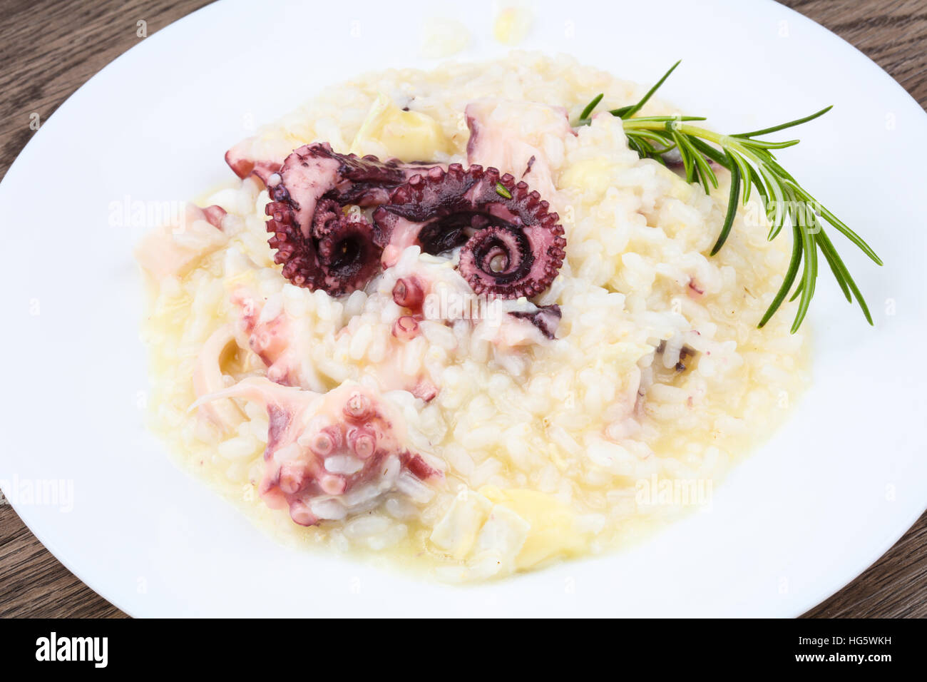 Risotto with octopus served green rosemary Stock Photo - Alamy