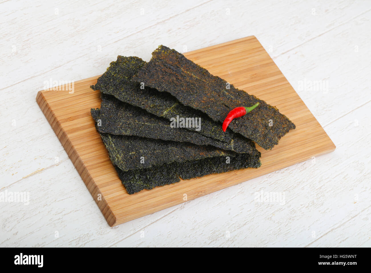 Spicy Nori seaweed sheets with pepper on wood Stock Photo - Alamy