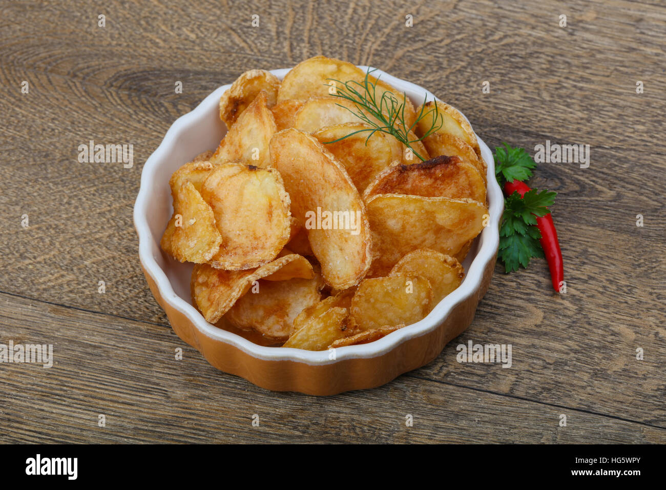 Natural potato chips heap in the bowl on wood background Stock Photo ...