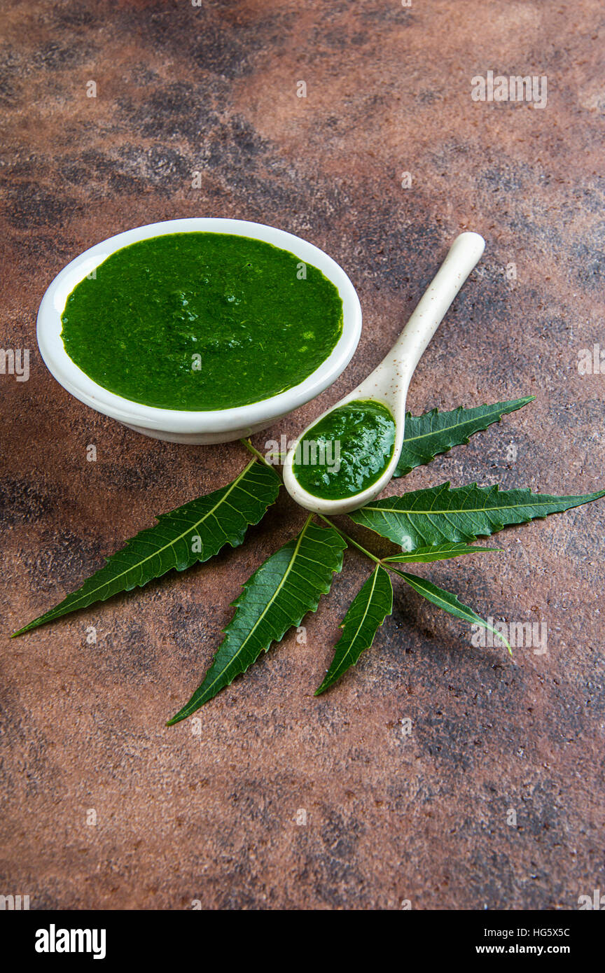 Medicinal Neem leaves with paste on stone background Stock Photo - Alamy