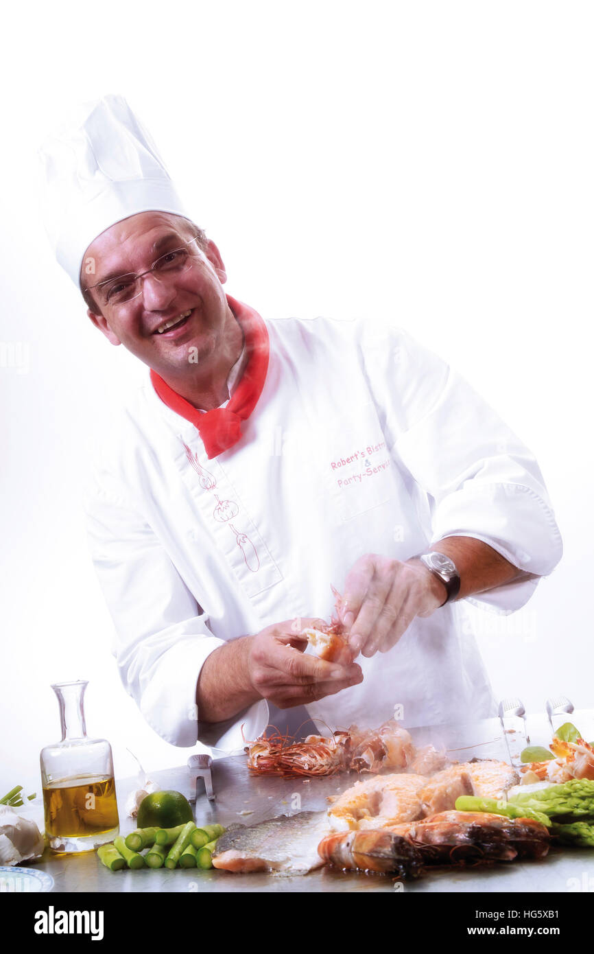 Chef preparing fresh seafood and vegetables at the teppan (teppanyaki ...