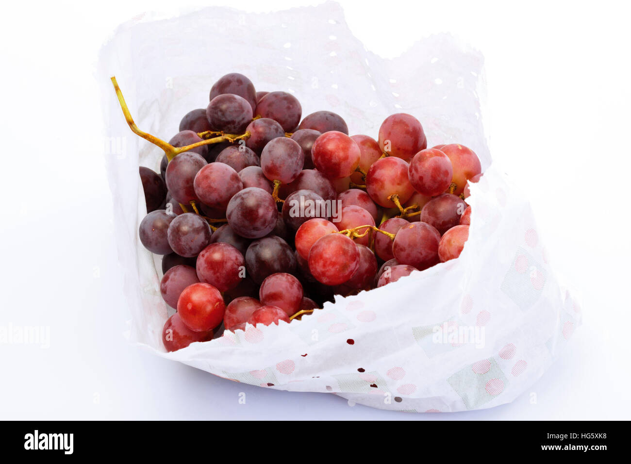 Bunch of red grapes in a white paper bag Stock Photo - Alamy