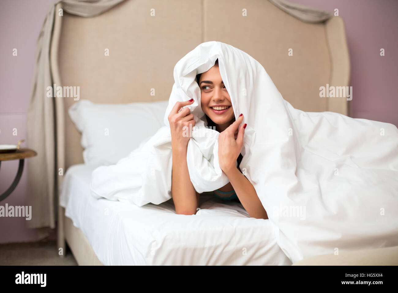 Woman hiding under blanket hi-res stock photography and images - Alamy