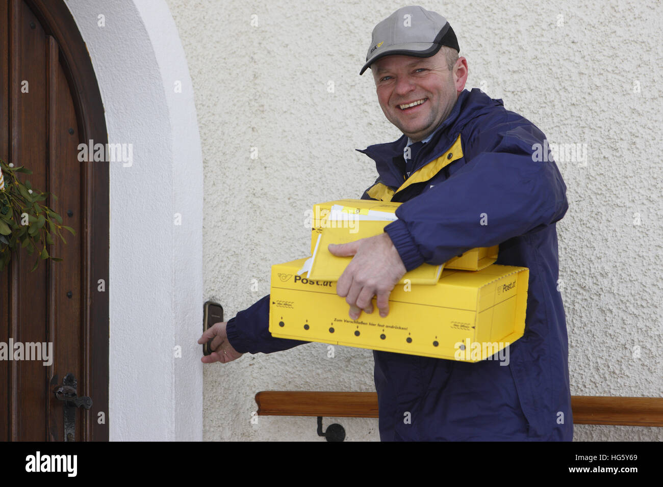 Postman with packages Stock Photo - Alamy