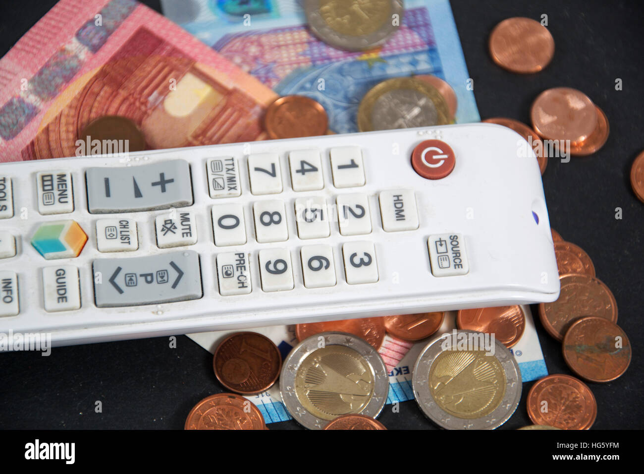 white remote with money Stock Photo - Alamy