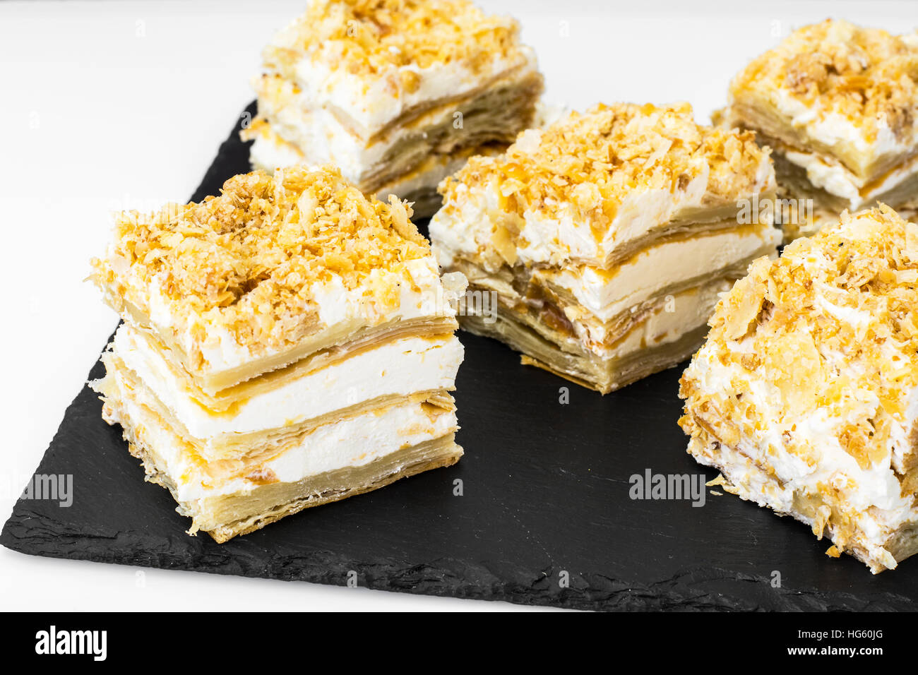 Portion cake of puff pastry with vanilla butter cream Stock Photo - Alamy